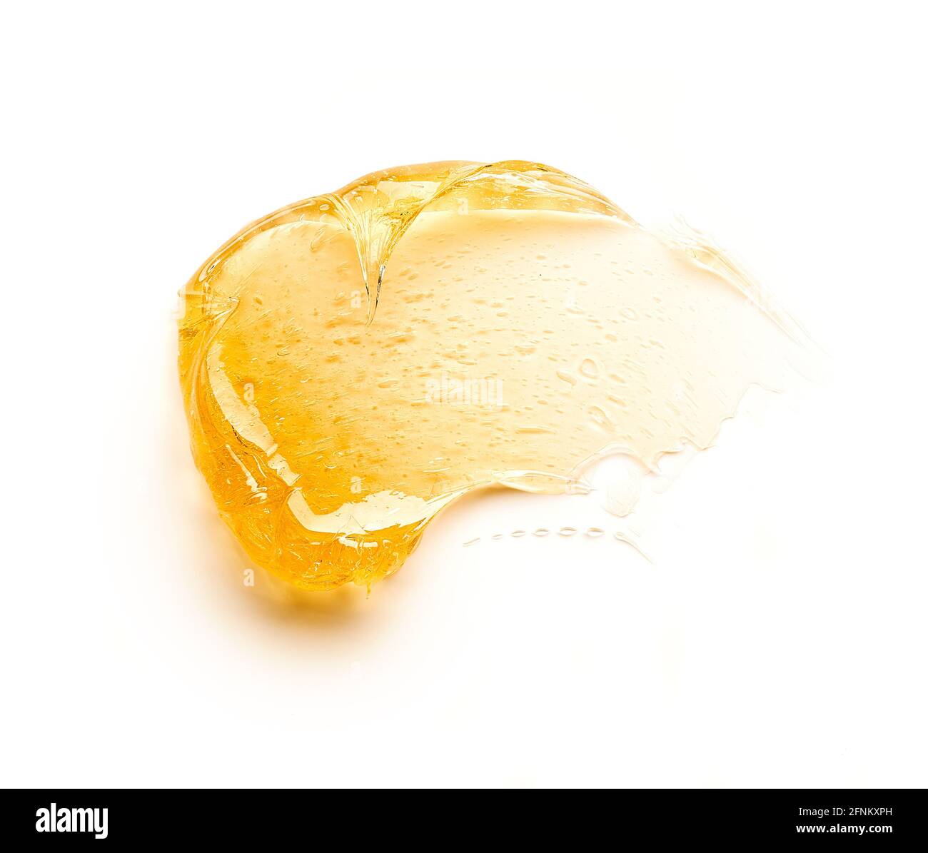 Transparent yellow smear of face cream or golden honey isolated on ...