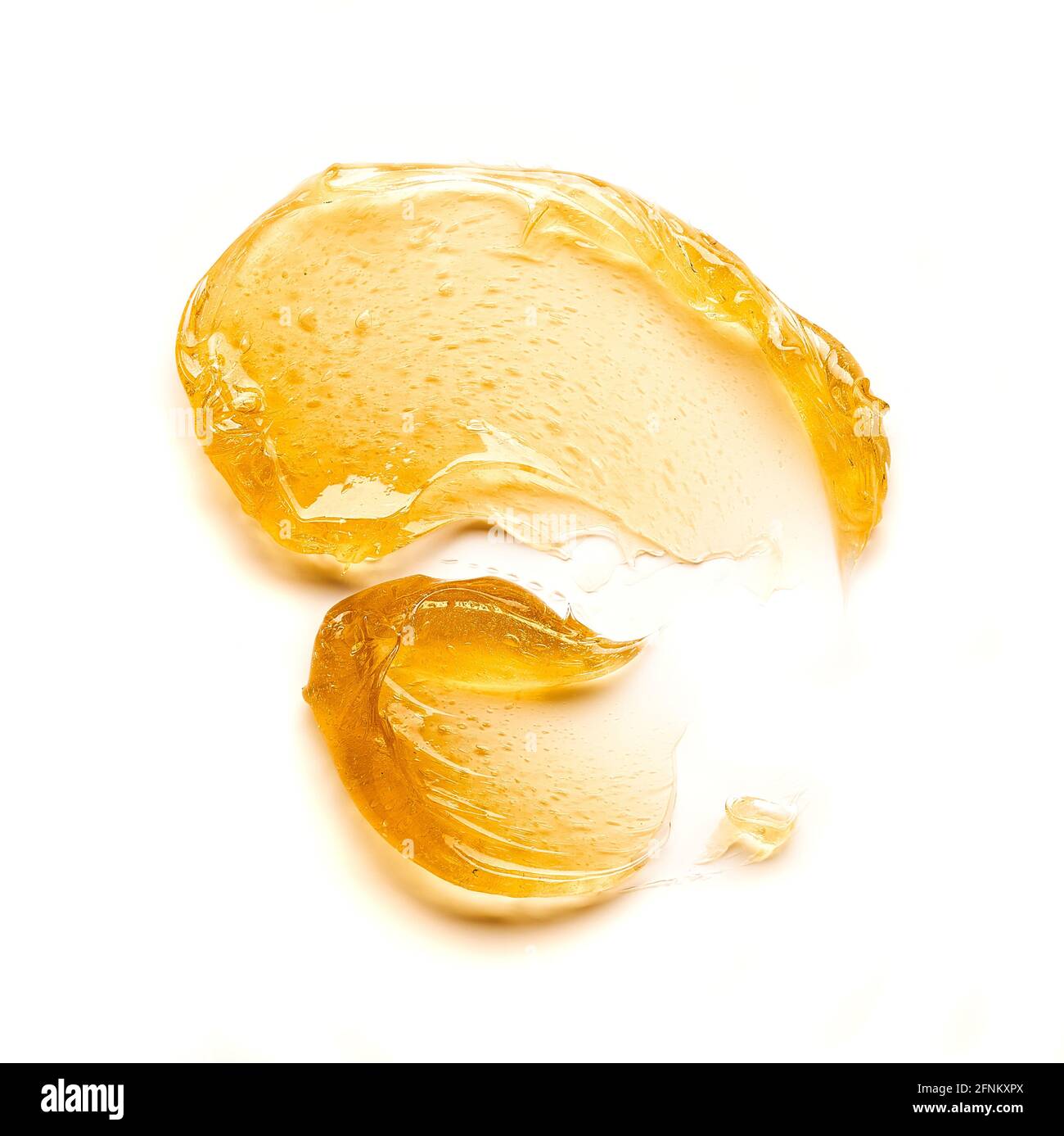 Transparent yellow smear of face cream or golden honey isolated on ...