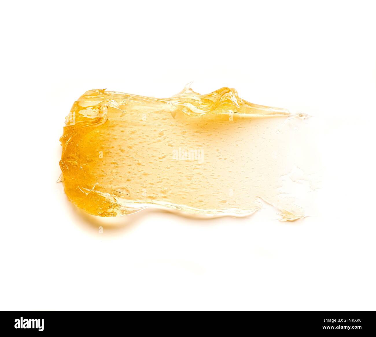 Transparent yellow smear of face cream or golden honey isolated on ...