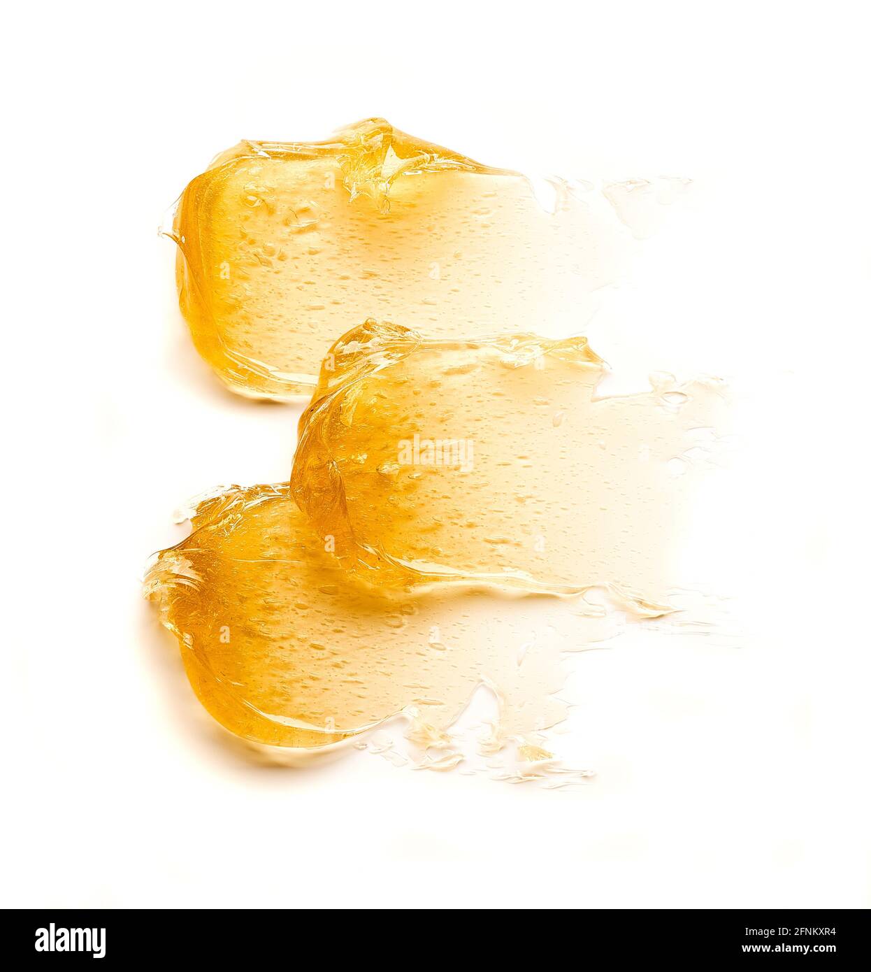Transparent yellow smear of face cream or golden honey isolated on ...