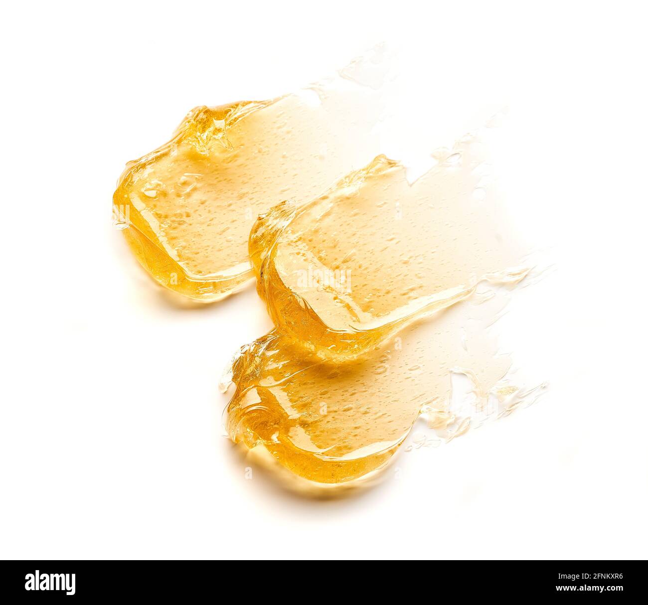 Transparent yellow smear of face cream or golden honey isolated on ...