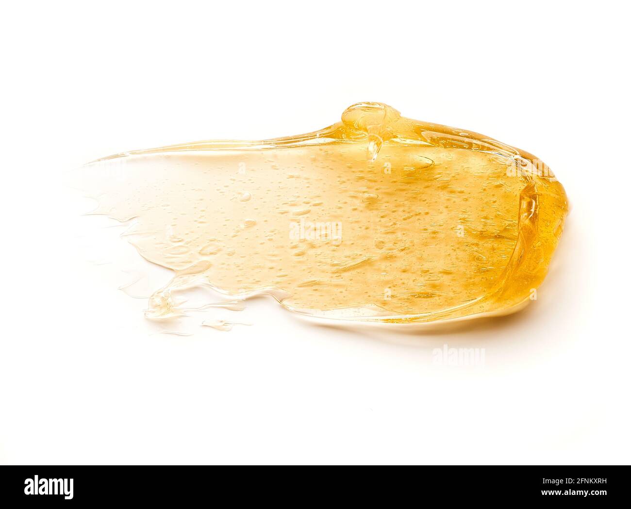 Transparent yellow smear of face cream or golden honey isolated on ...