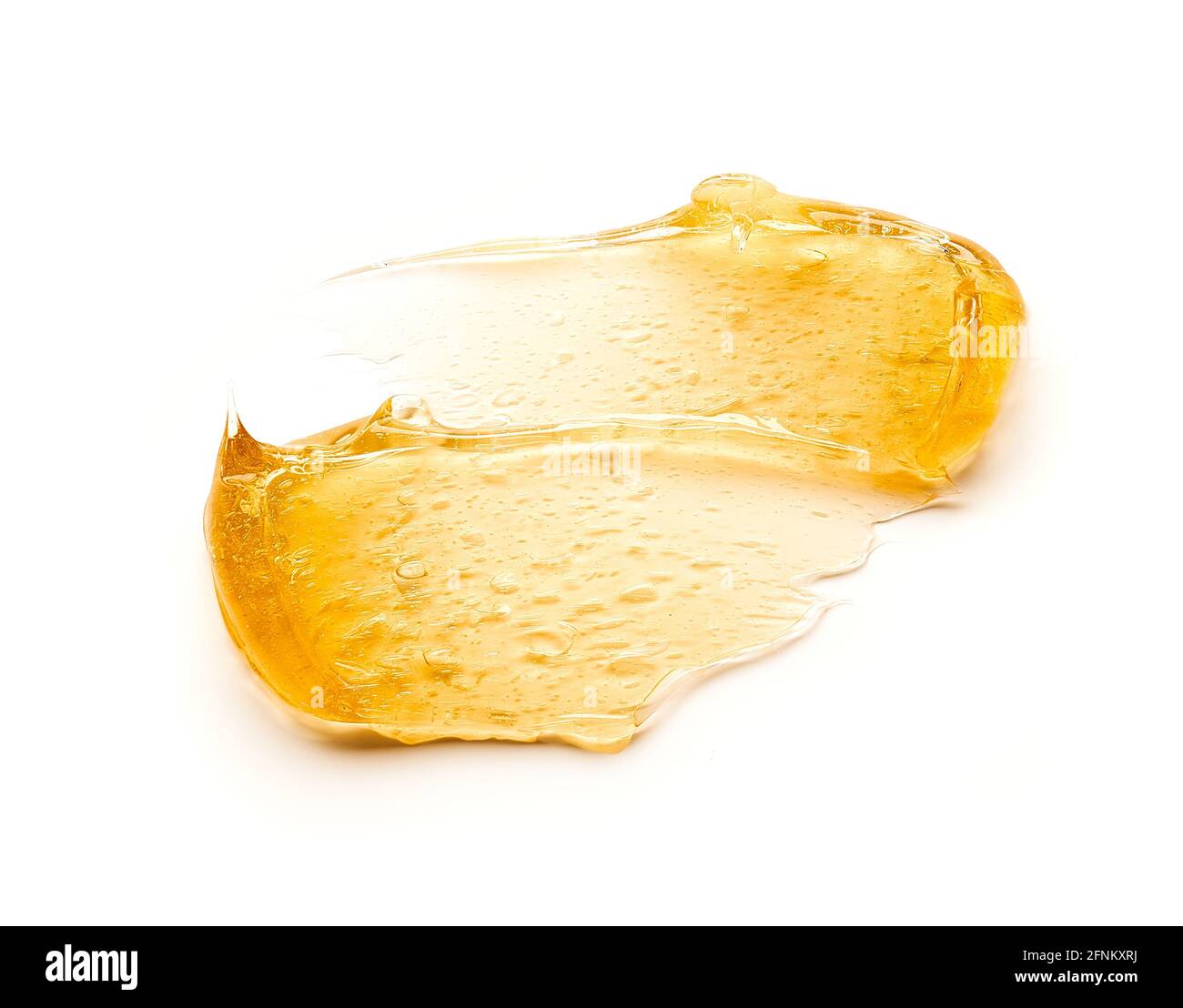 Transparent yellow smear of face cream or golden honey isolated on ...
