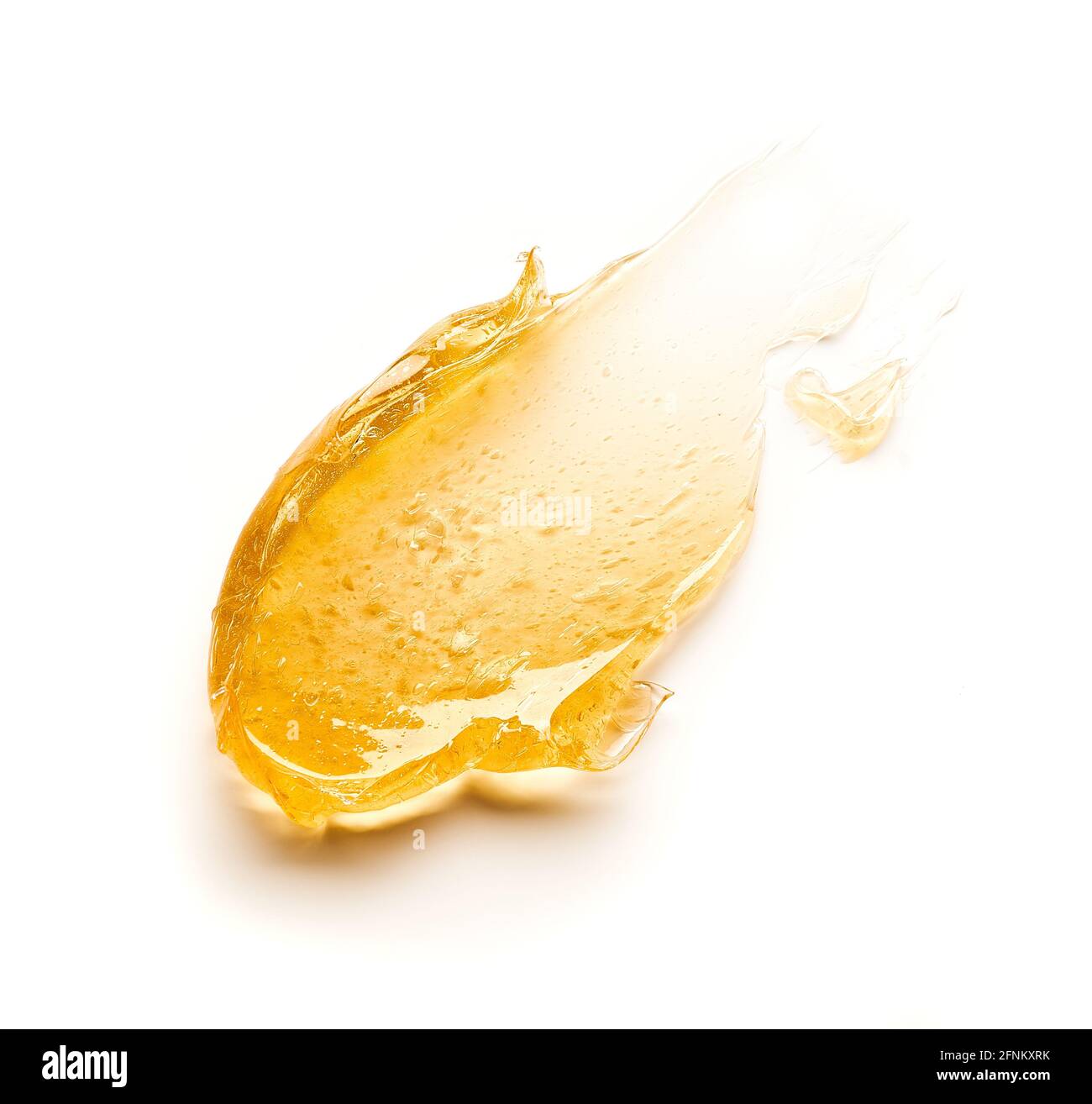 Transparent yellow smear of face cream or golden honey isolated on ...