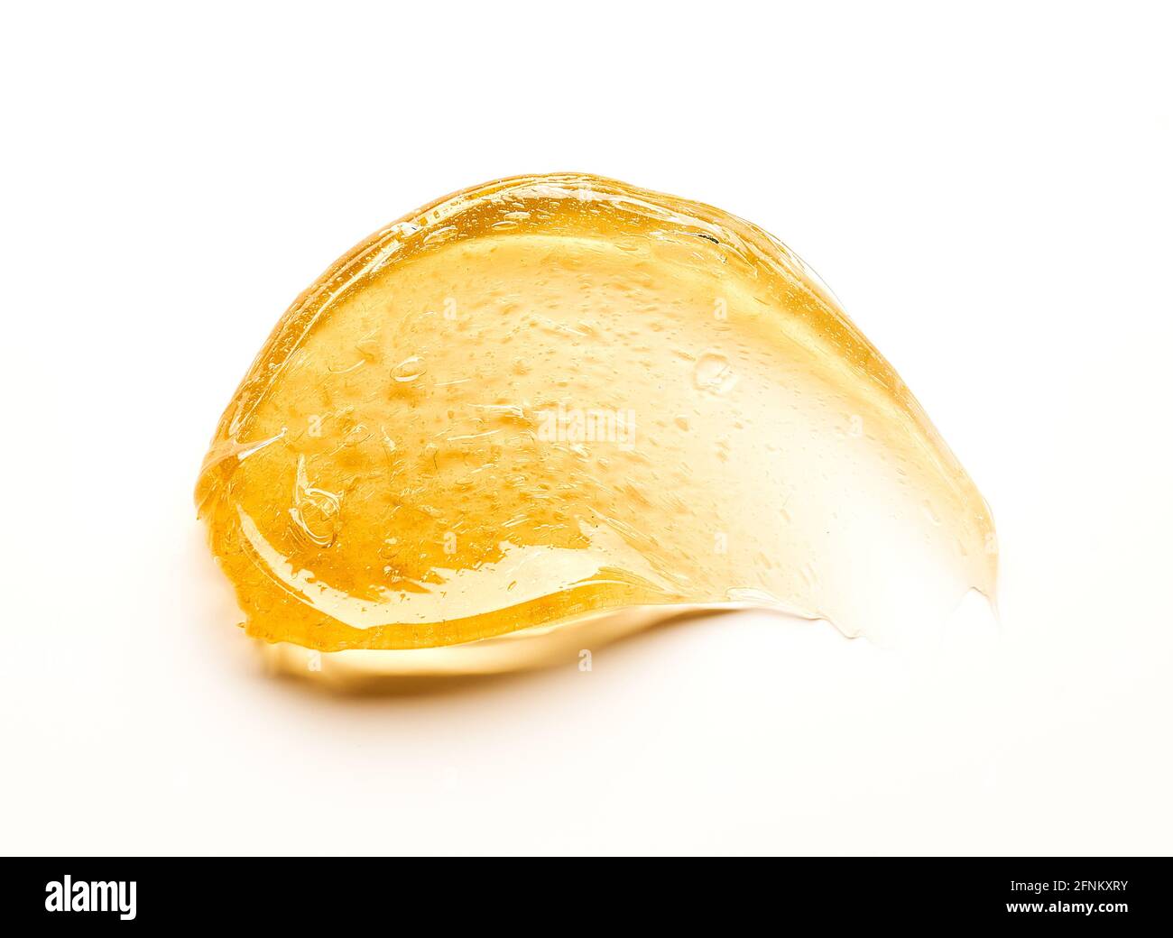 Transparent yellow smear of face cream or golden honey isolated on ...