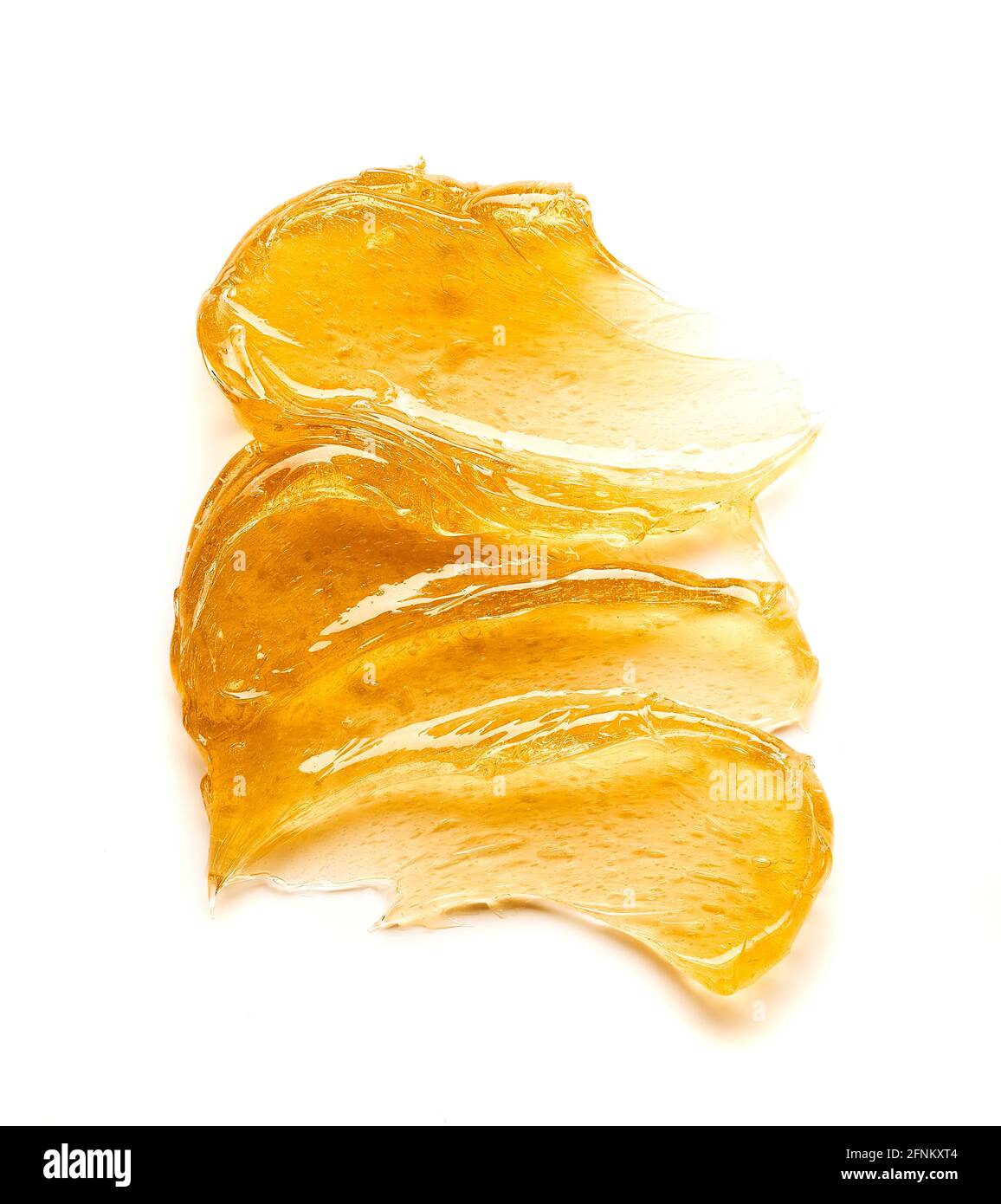 Transparent yellow smear of face cream or golden honey isolated on ...