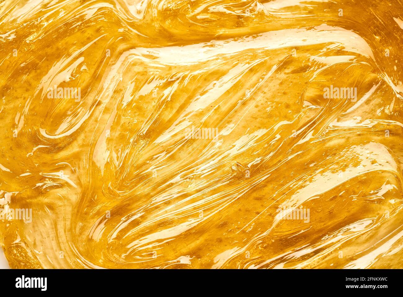 Transparent yellow smear of face cream or golden honey isolated on ...