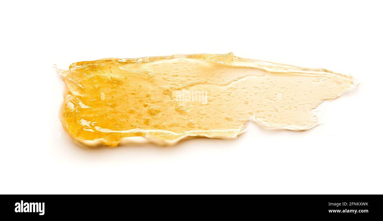 Transparent yellow smear of face cream or golden honey isolated on ...