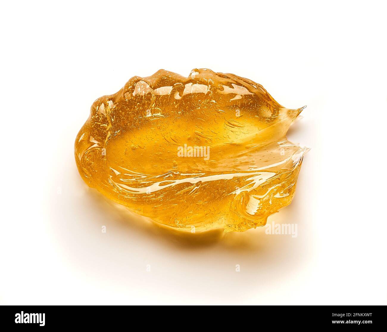 Transparent yellow smear of face cream or golden honey isolated on ...