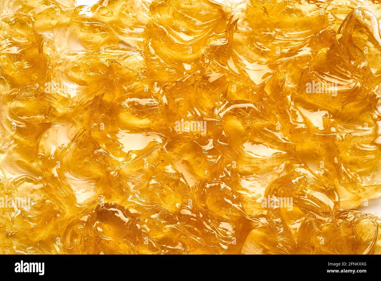 Transparent yellow smear of face cream or golden honey isolated on ...