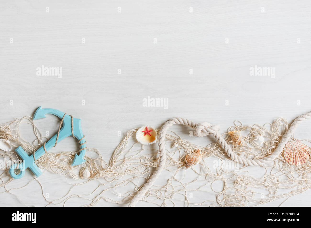 Sea background with fishing net, anchor and seashells top view on white ...