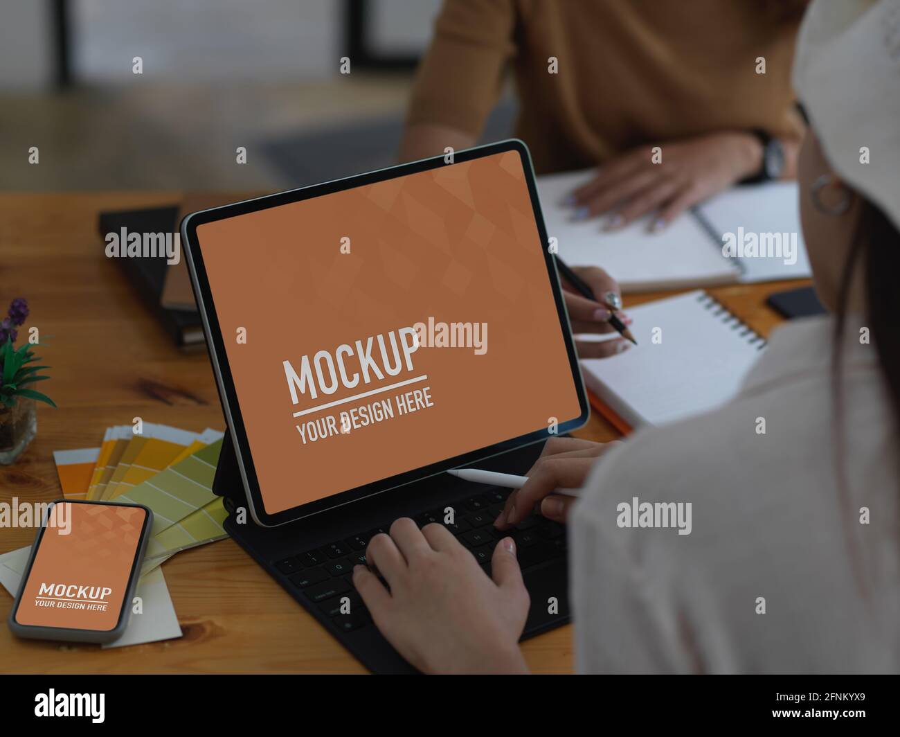 Cropped shot of female hands typing on tablet keyboard while working ...