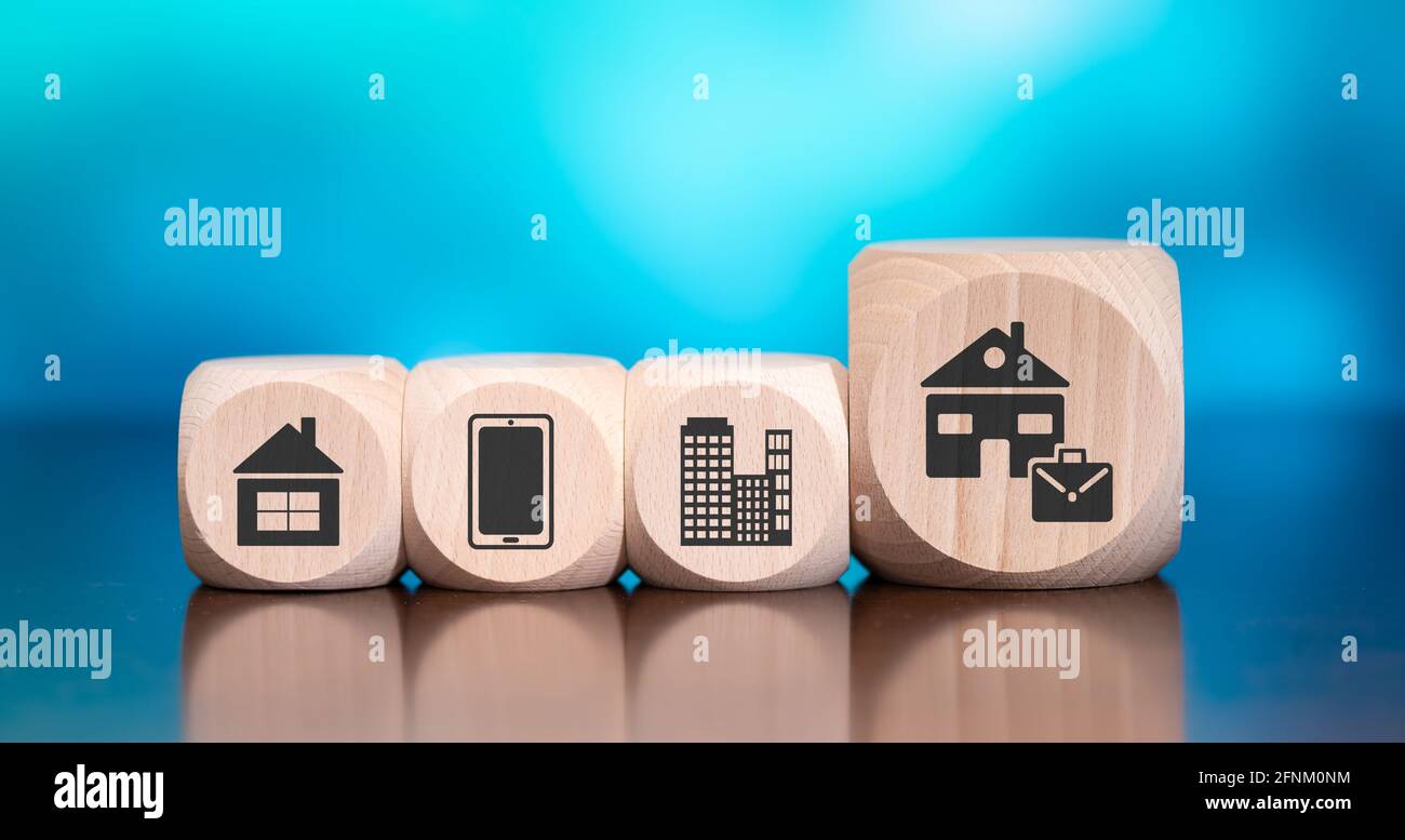 Wooden blocks with symbol of work from home concept on blue background ...