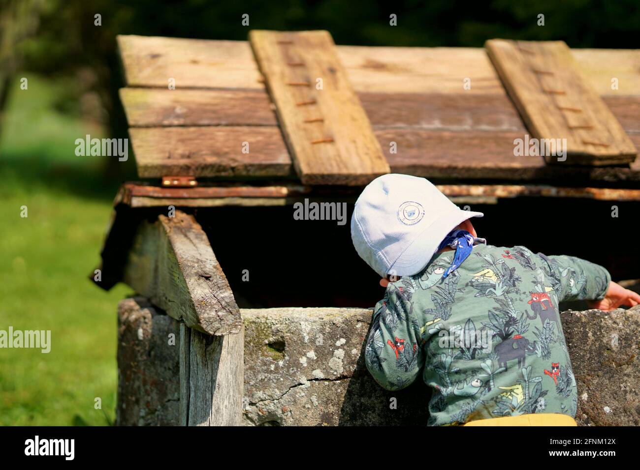 The Little Child Looks Into The Well Stock Photo - Alamy