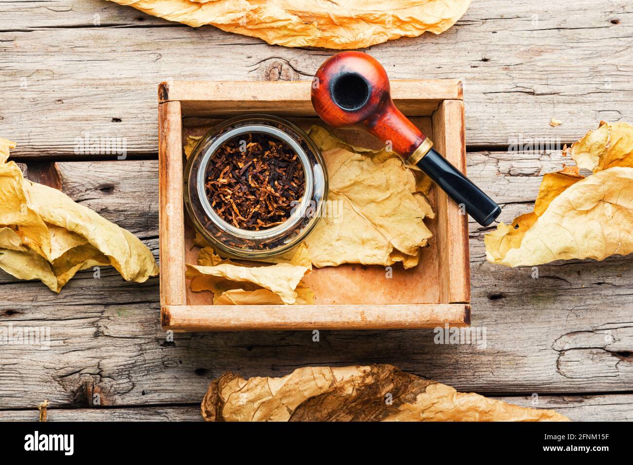 Tobacco pipe, tobacco leaf and pipe tobacco.Smoking pipe on rustic ...