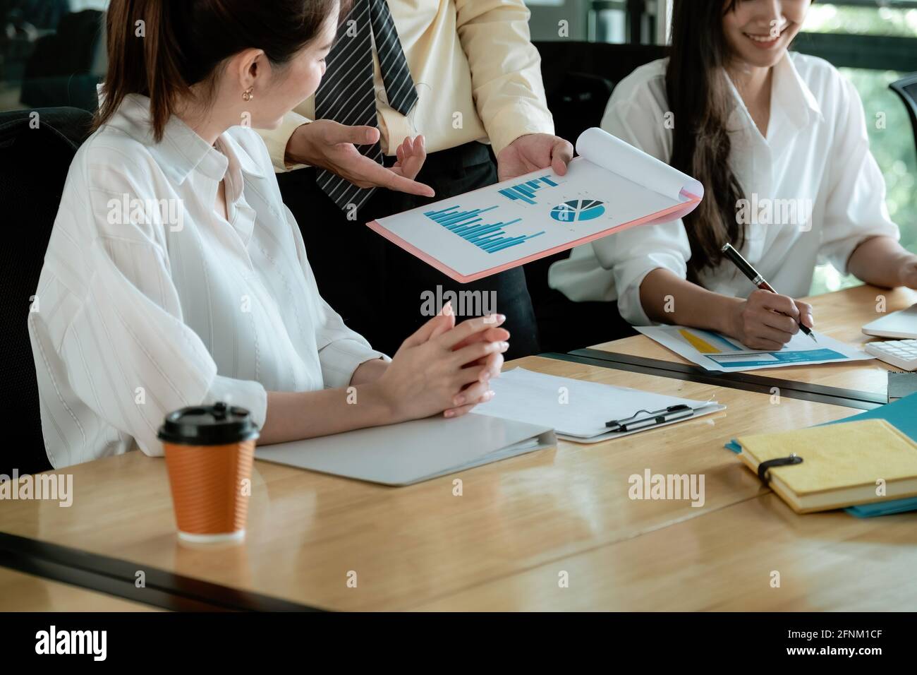Business advisor working together in the office discussing documents ...