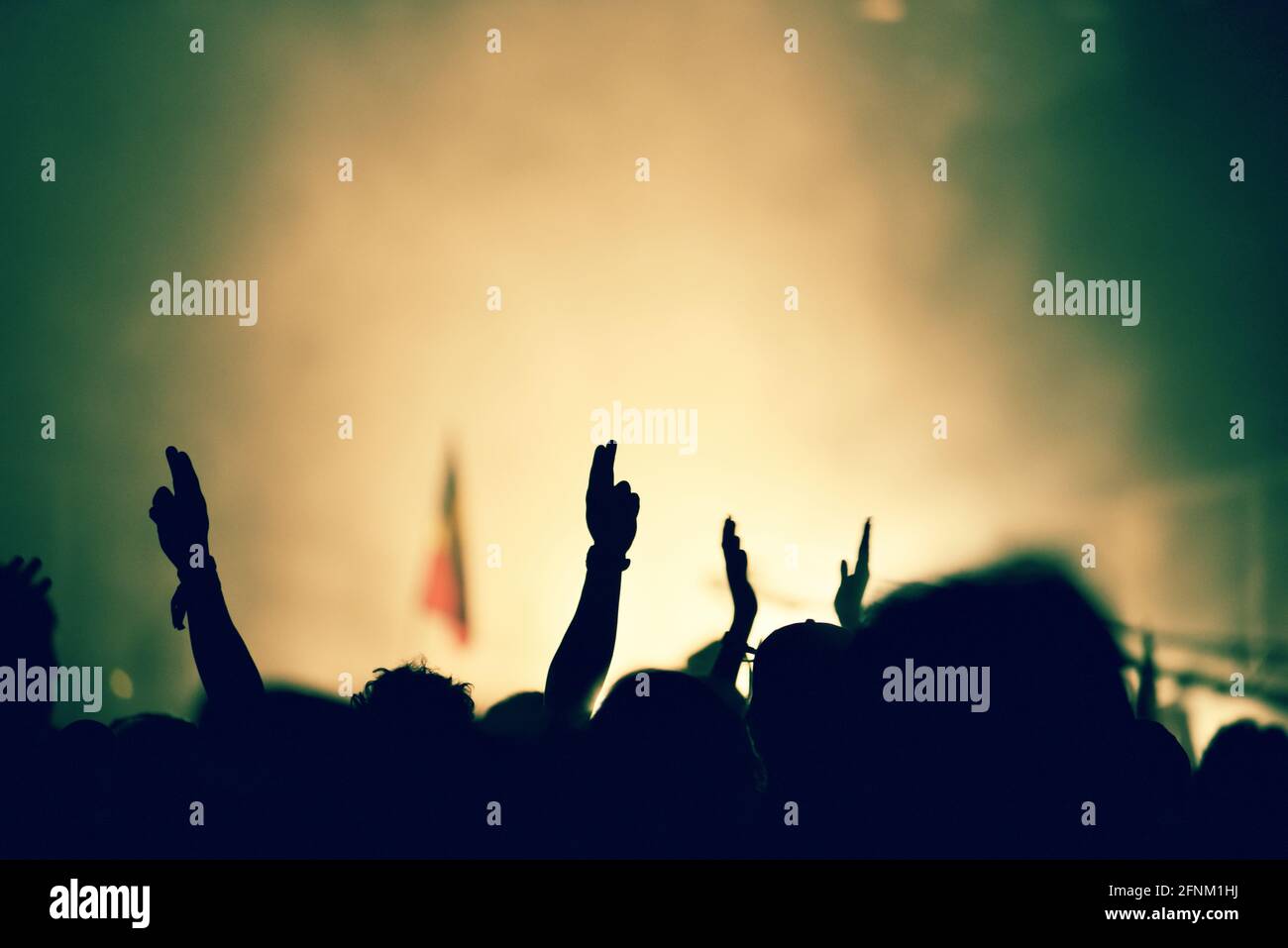 Silhouette of hands on a concert in front of bright stage lights Stock ...