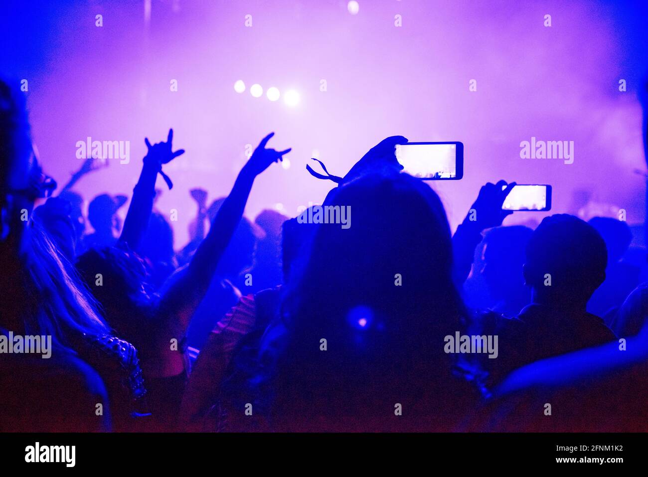Silhouette of hands recording a concert with smart phones. Crowd of ...