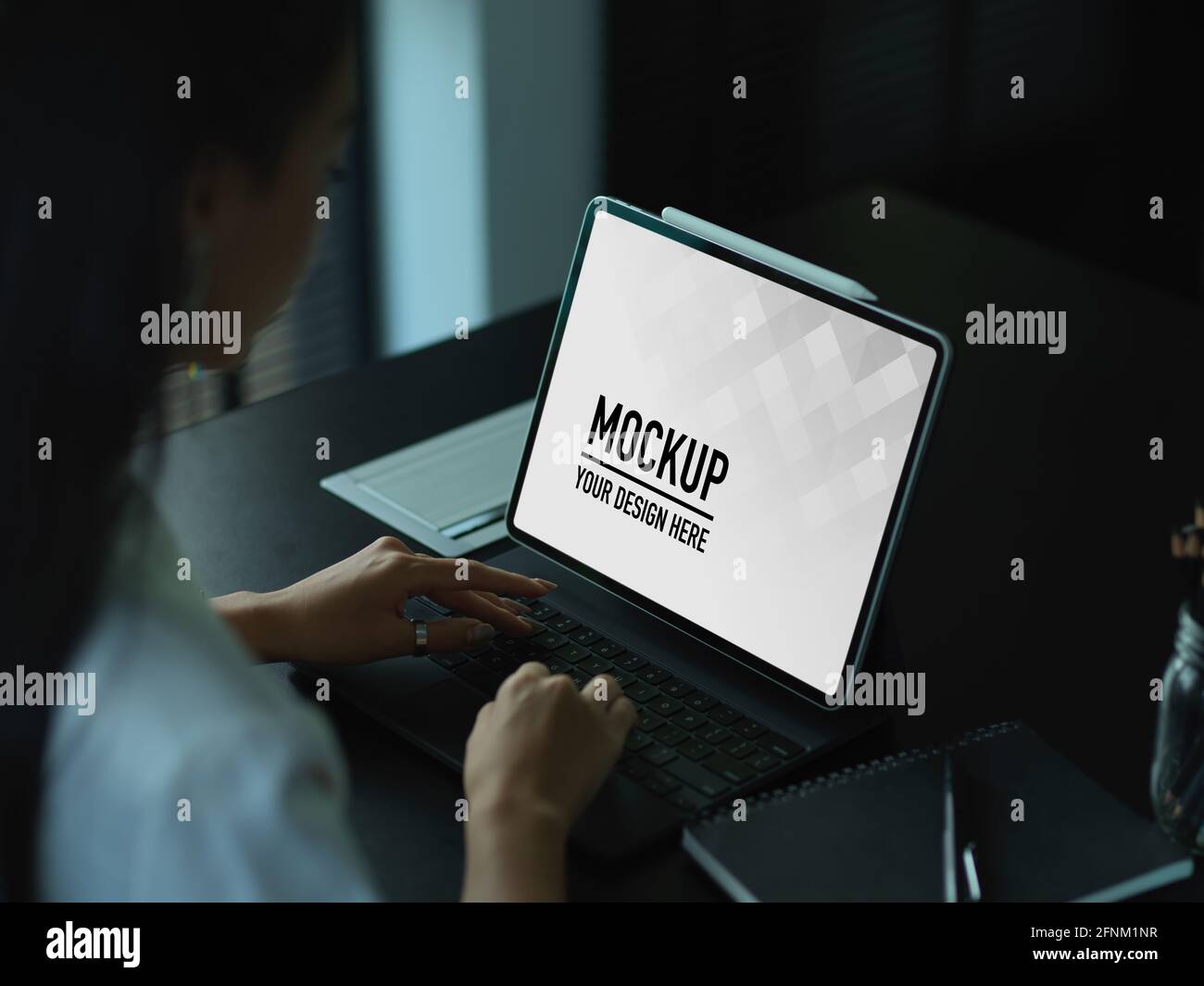 Cropped shot of female office worker typing on tablet keyboard include ...