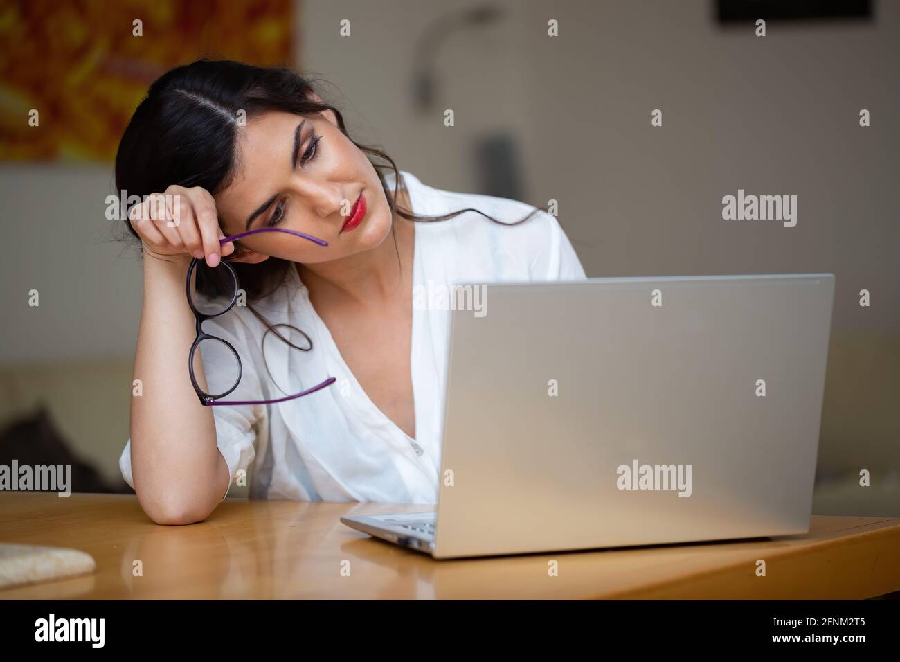 Tired businesswoman supporting her head while working from home Stock ...
