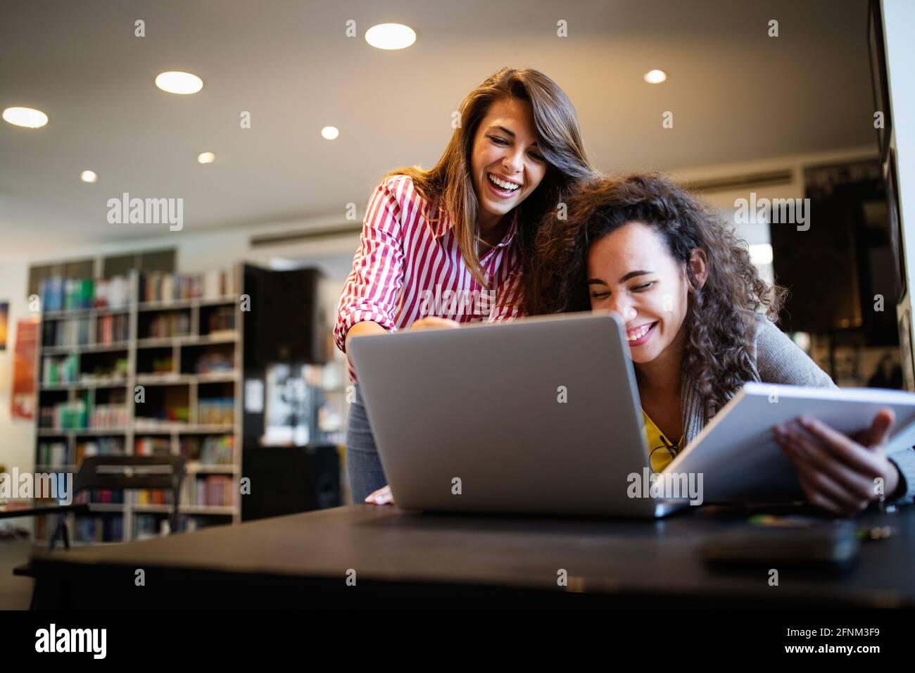 Group of college students studying in the school library Stock Photo ...