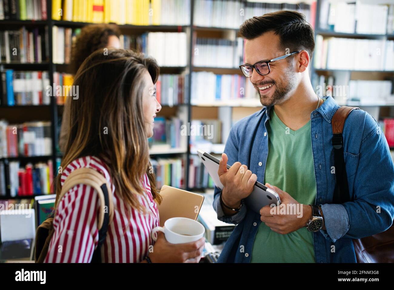 Students are studying together in library. Couple, study, technology ...