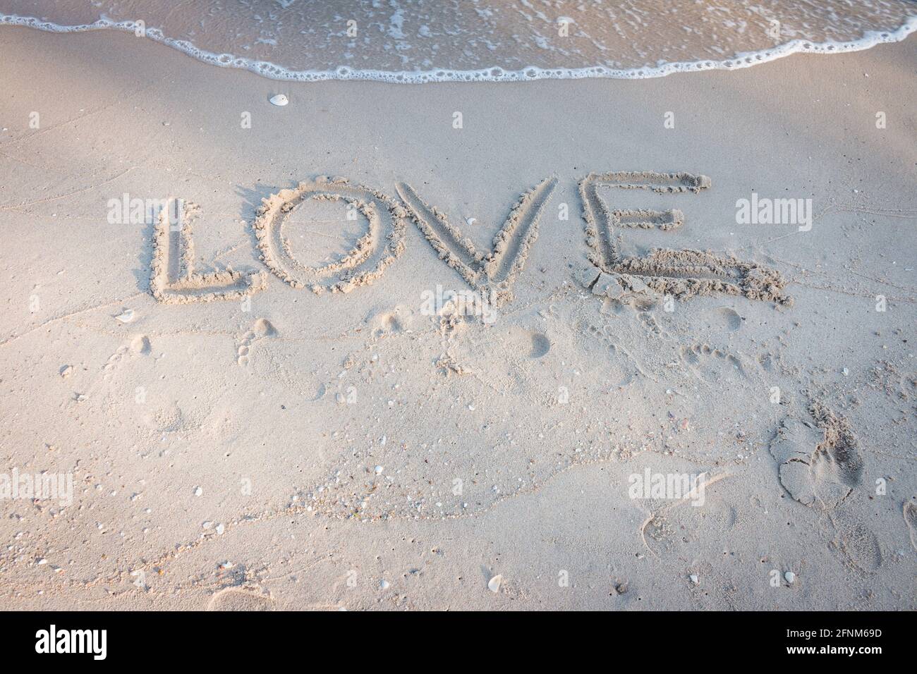 love message written in sand background Stock Photo - Alamy