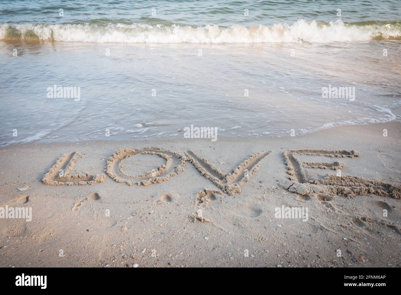 love message written in sand background Stock Photo - Alamy
