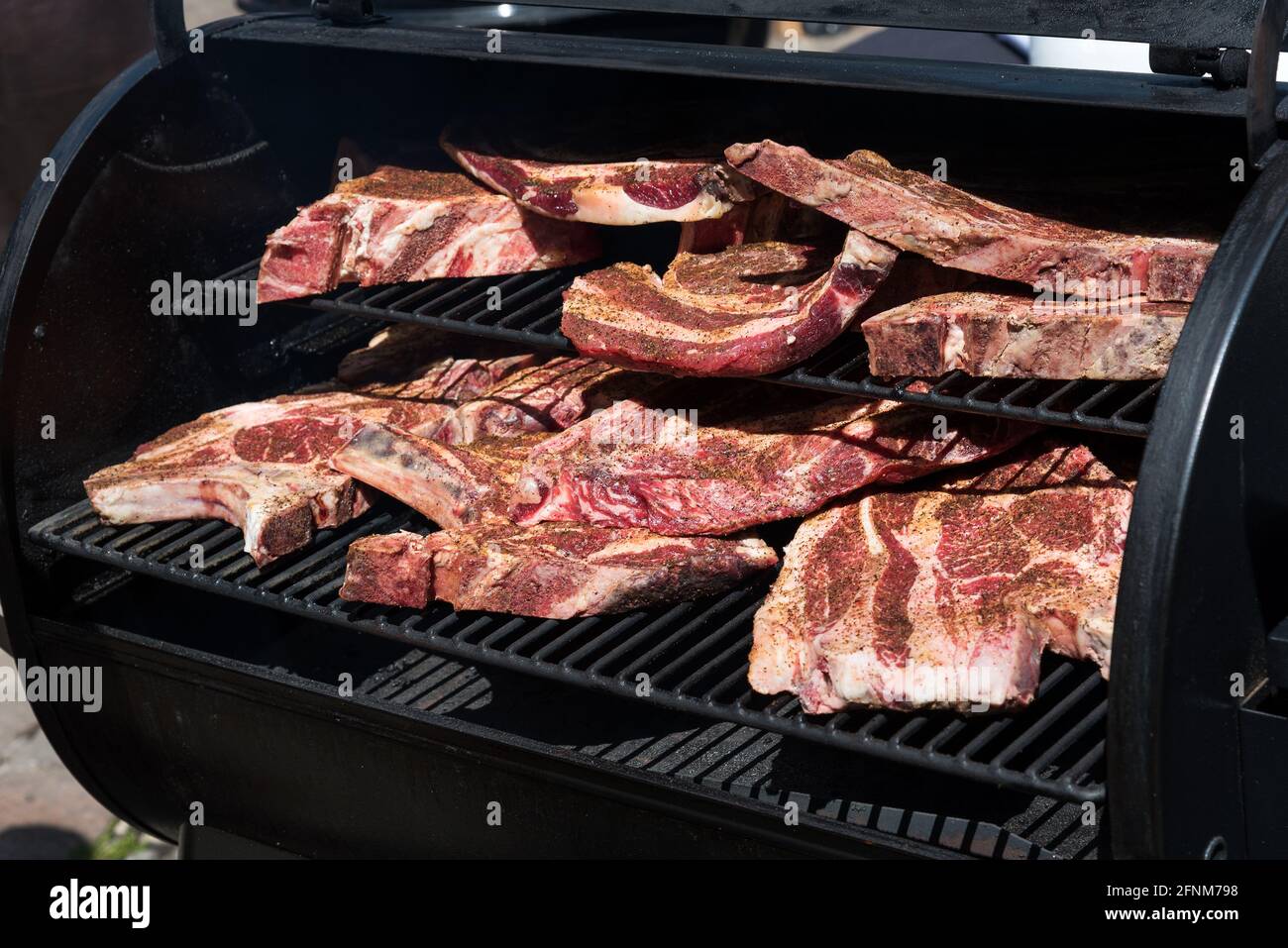 Assorted portions of raw seasoned fatty prime ribs ready for the BBQ ...