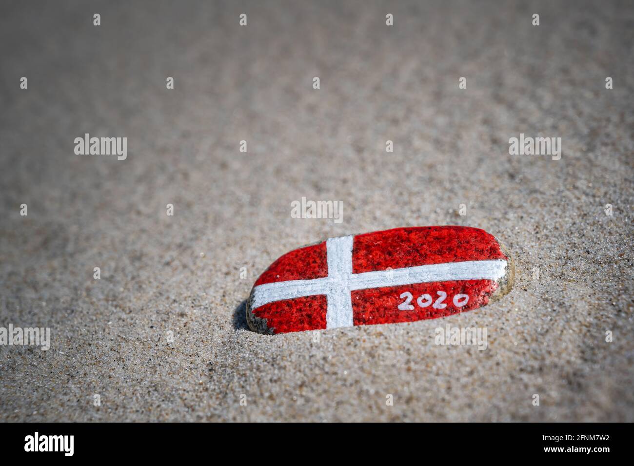 Stone painted with denmark banner at beach in water Stock Photo - Alamy