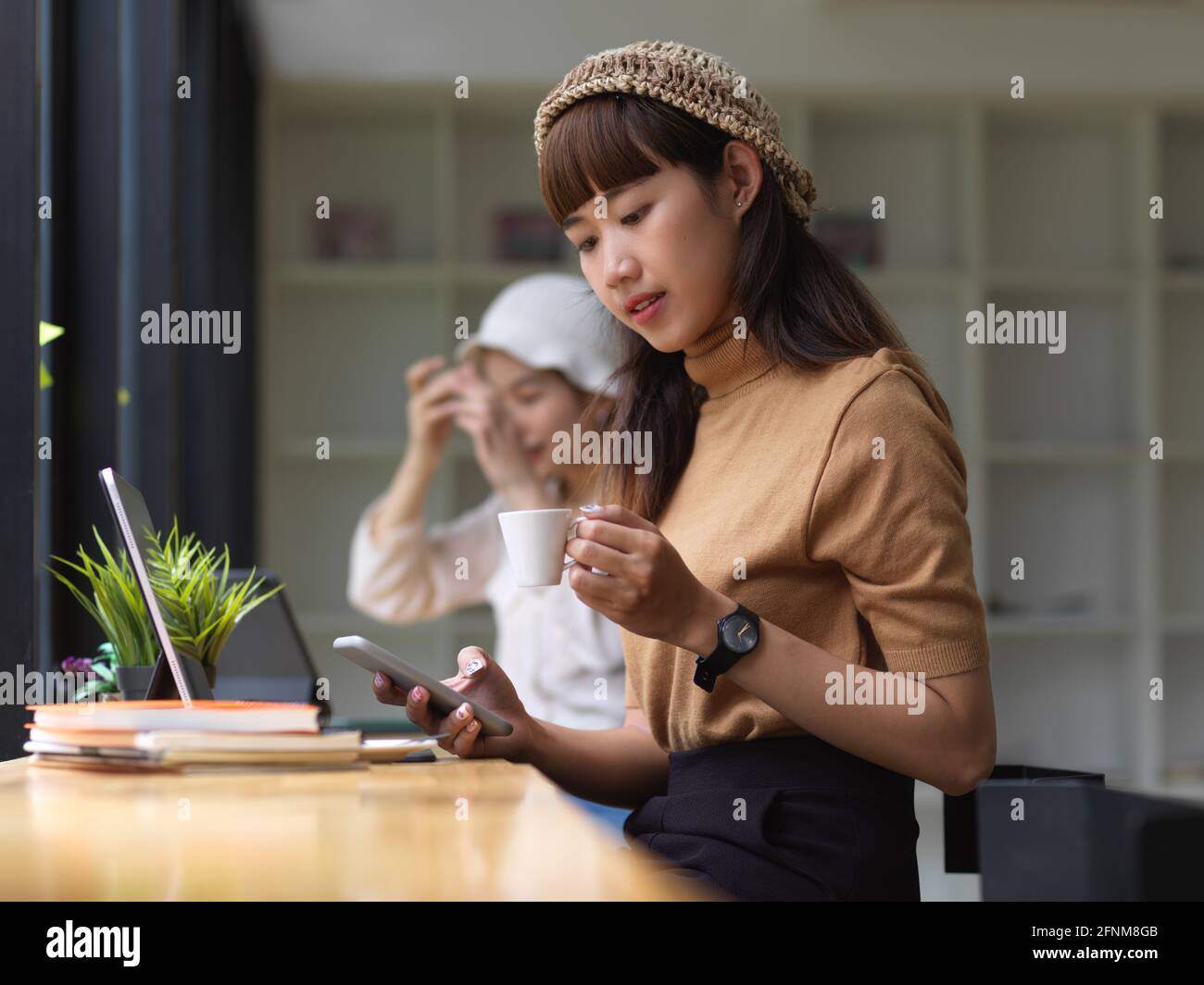 Portrait of female teenager using smartphone and take a coffee break ...