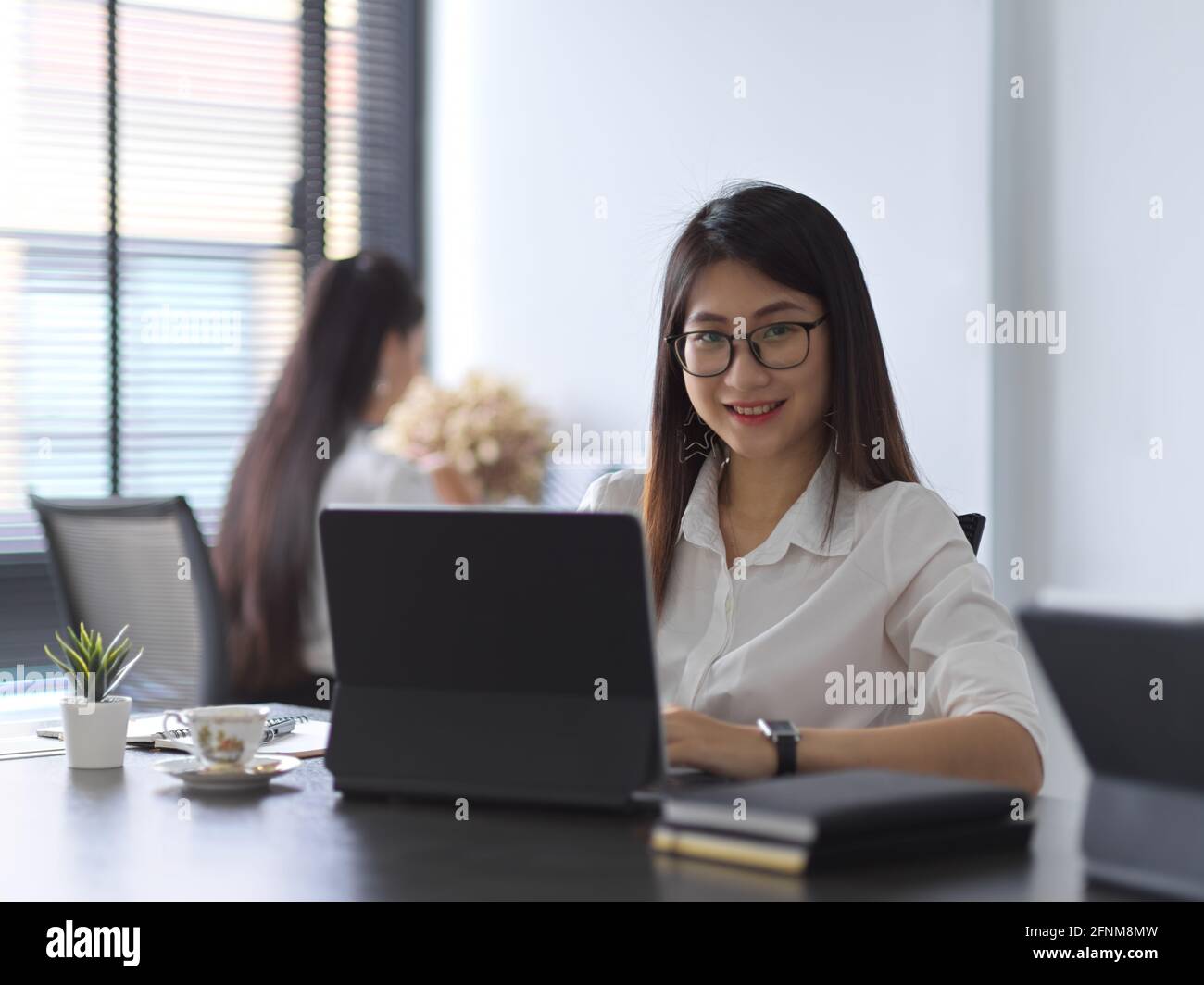Office worker looking at camera hi-res stock photography and images - Alamy