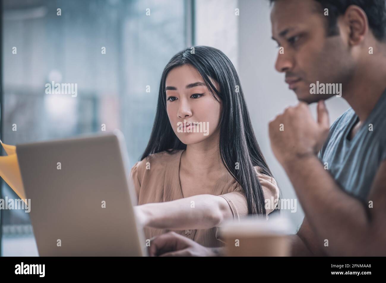 Colleagues working in the office and looking concentrated Stock Photo ...