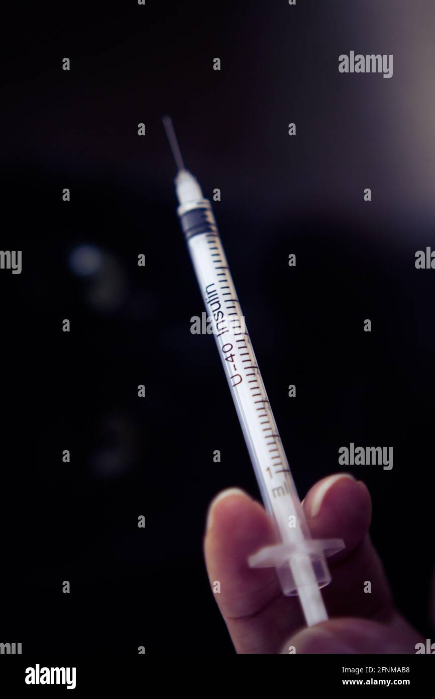 Insulin injecting syringe held by nurses hand. Copy space Stock Photo ...