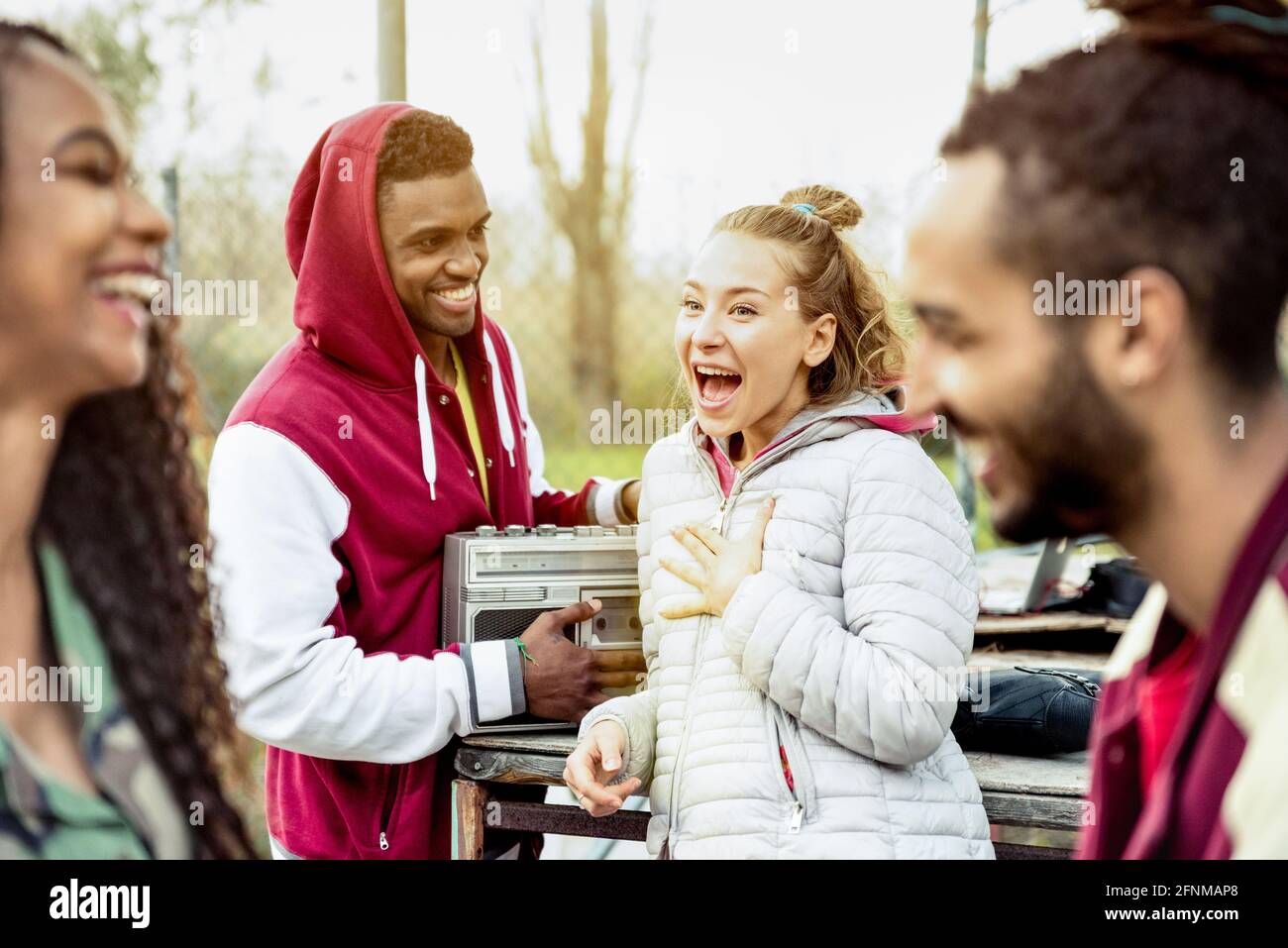 Group Of Multiracial Friend Couples Having Fun Time Out At Park In