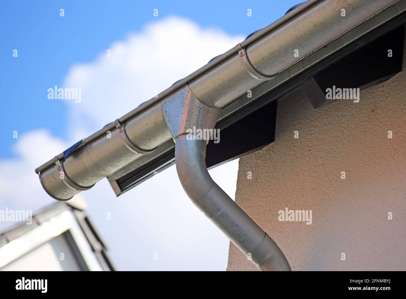 Roof gutter on a new tiled roof Stock Photo - Alamy