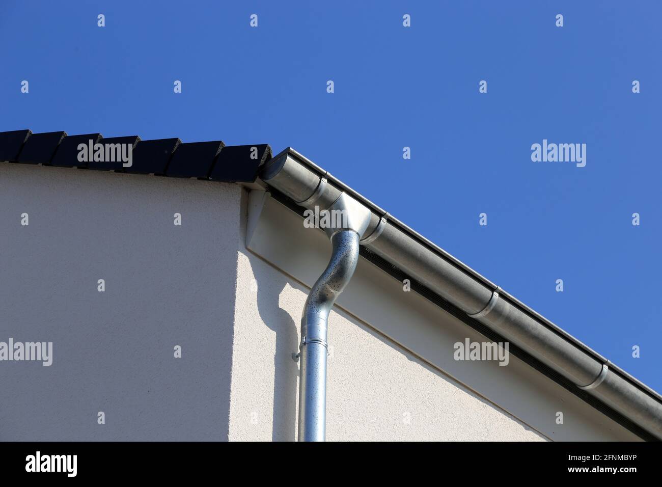 Roof gutter on a new tiled roof Stock Photo - Alamy