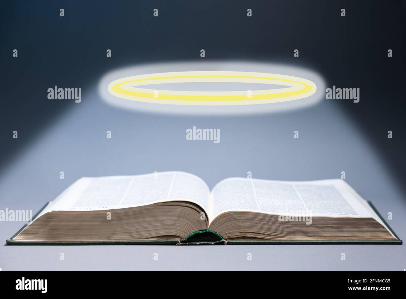World Religion Day. An open book of the Holy Bible, with a glowing halo ...
