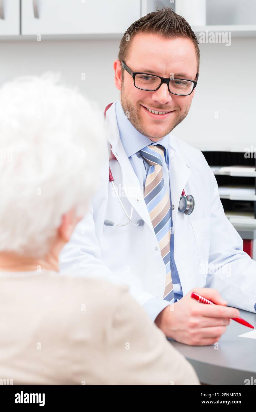Doctor seeing senior patient in practice Stock Photo - Alamy