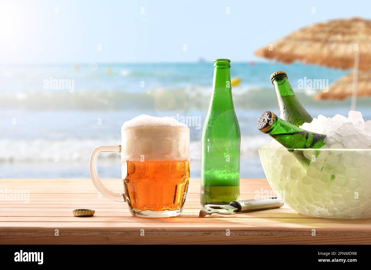 Beer mug and a glass container with ice filled with beer bottles on ...