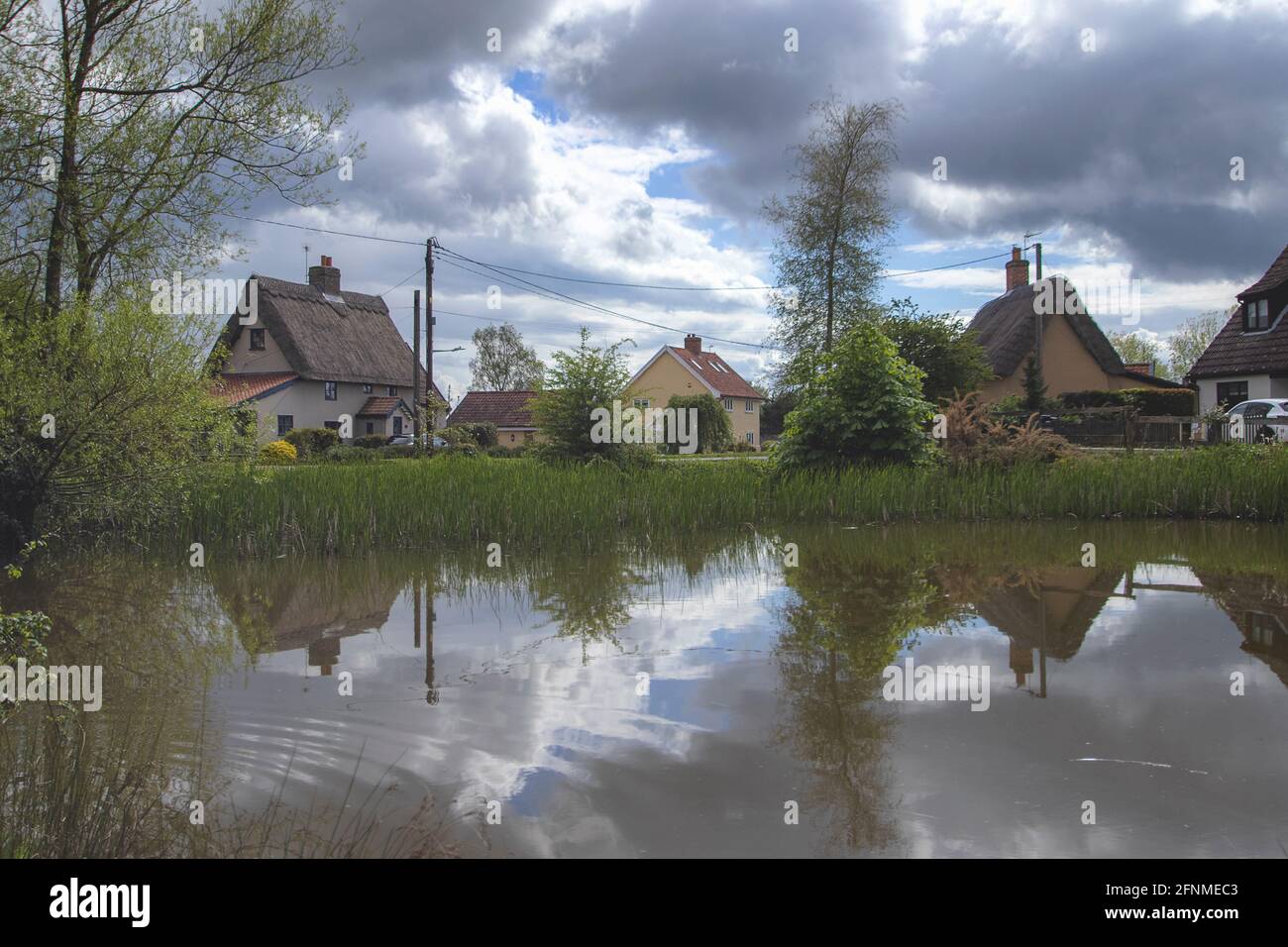 Reflections in the duck pond in the village of Bacton in Suffolk, UK ...