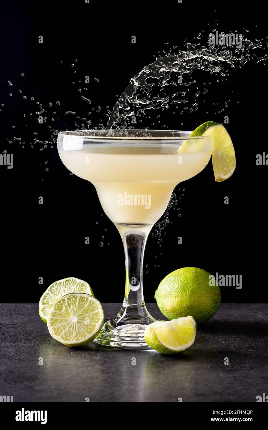 Classic daiquiri cocktail splashing in glass on black background Stock ...
