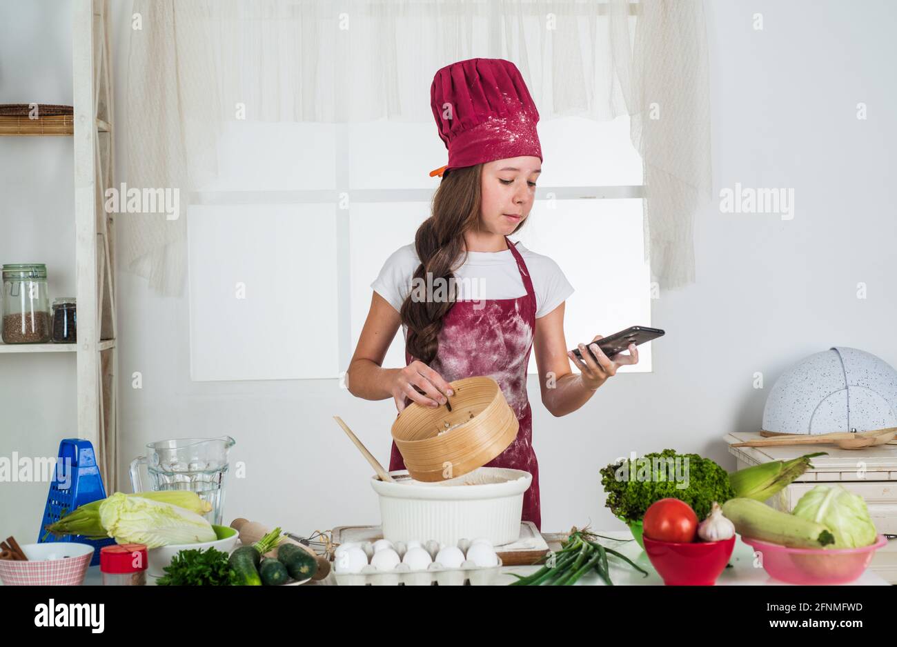 child girl cooking meal from healthy and organic products only ...