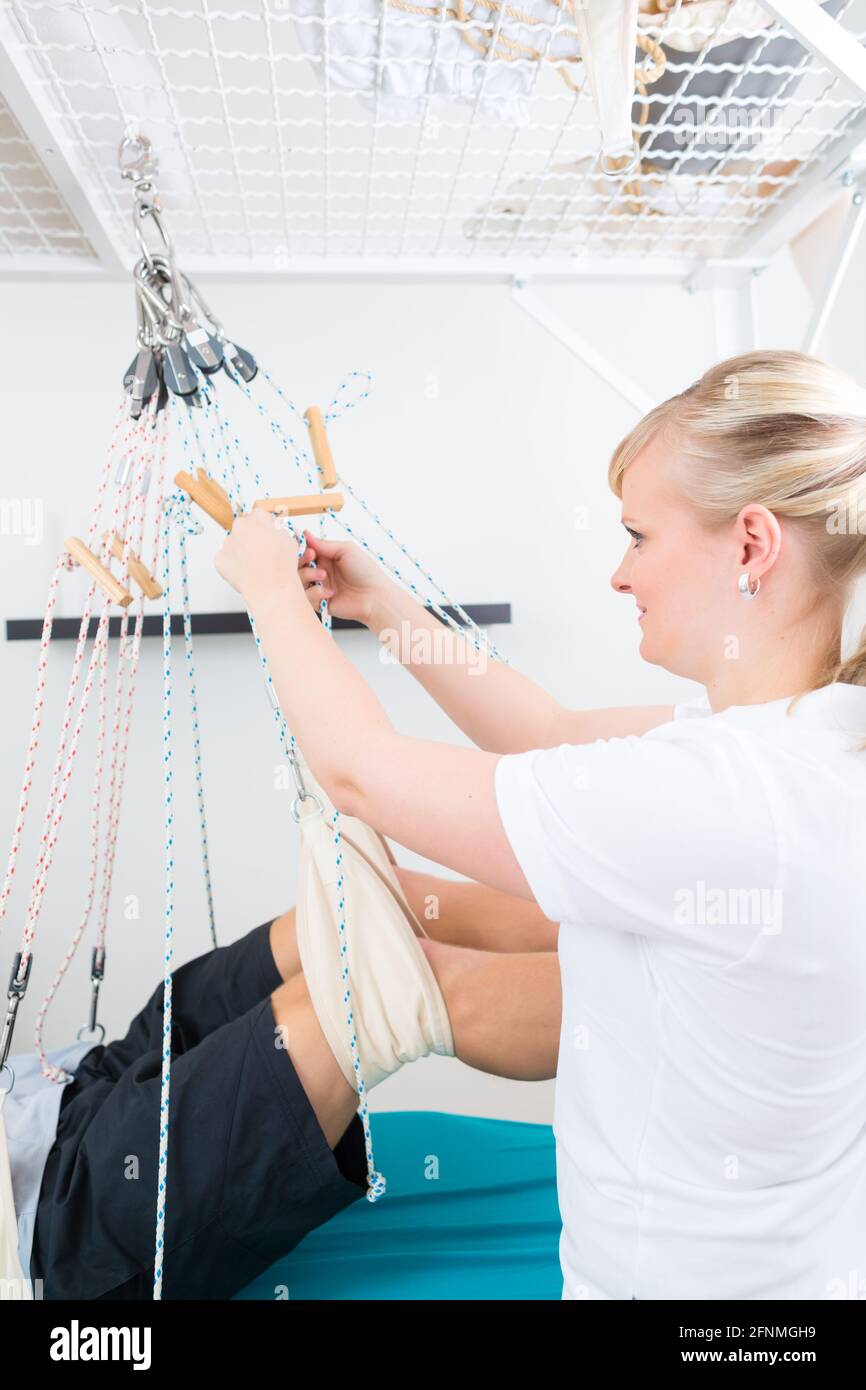 Patient at the physiotherapy doing physical exercises with his ...