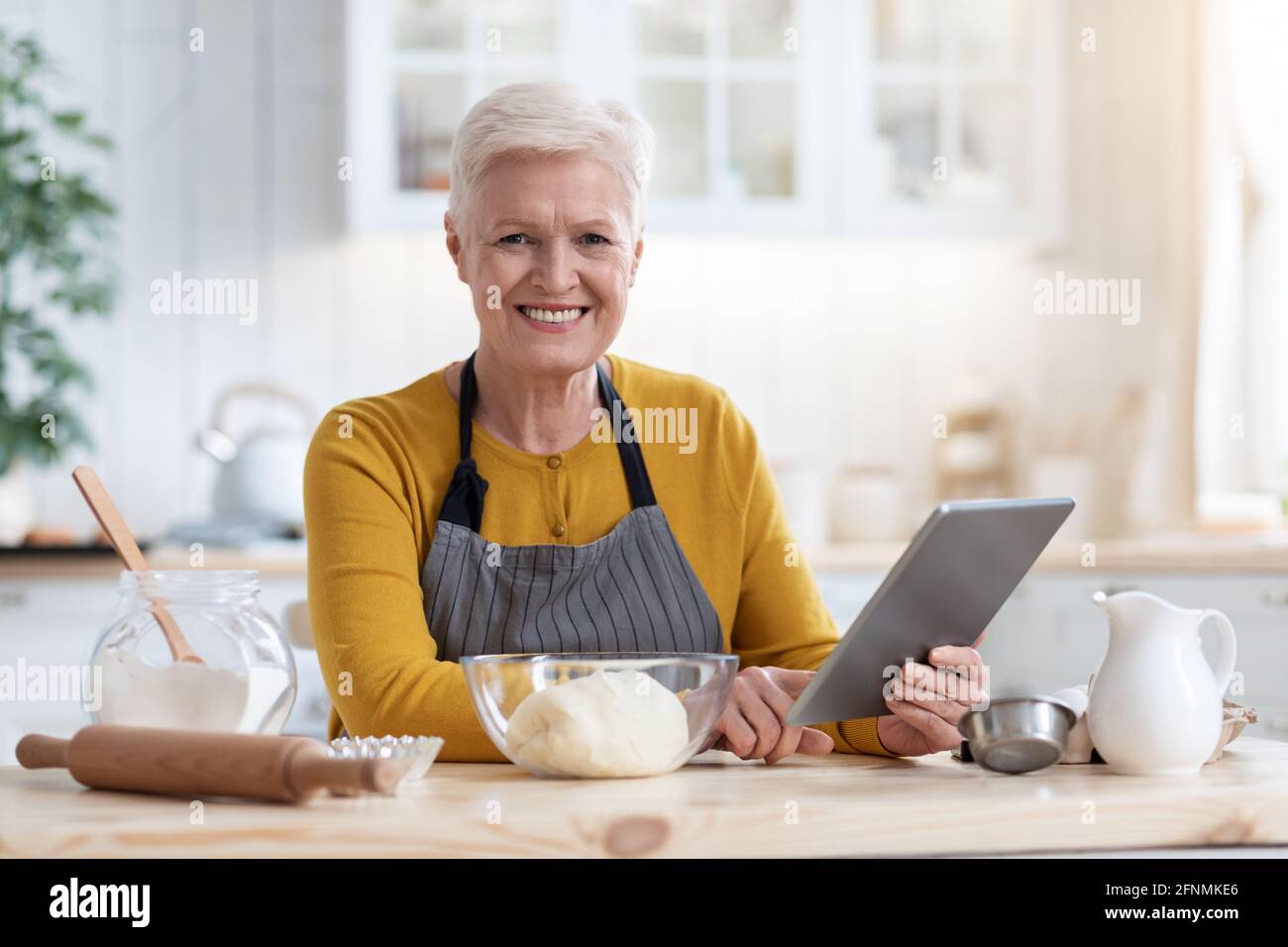 Old woman cooking hi-res stock photography and images - Alamy