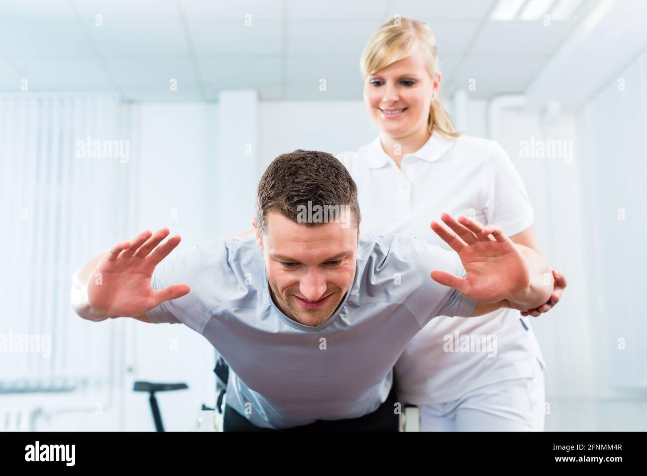 Patient at the physiotherapy doing physical exercises with therapist ...