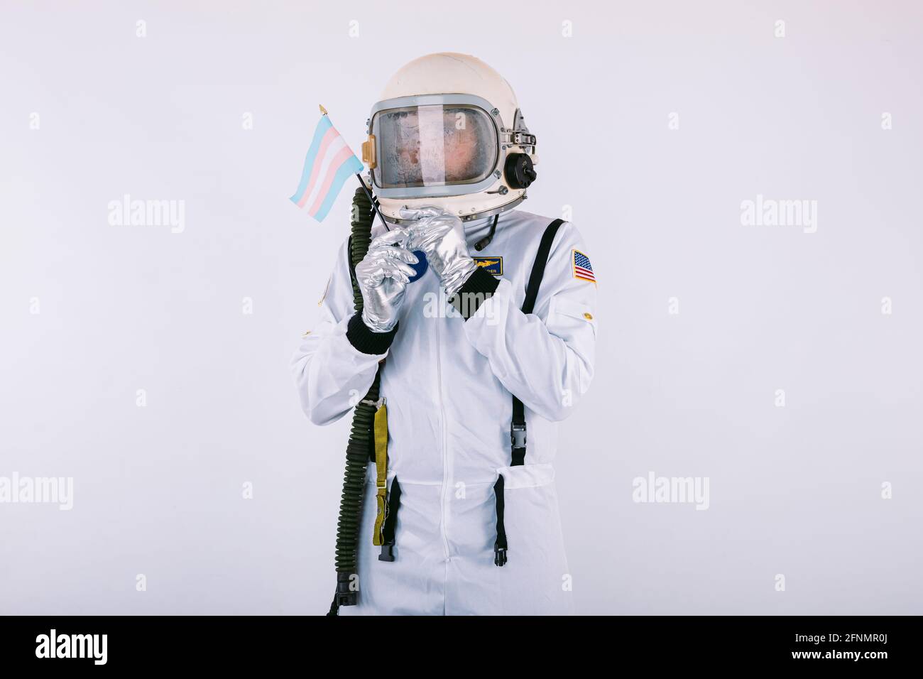 Gay transsexual male cosmonaut with serious gesture in space suit and ...