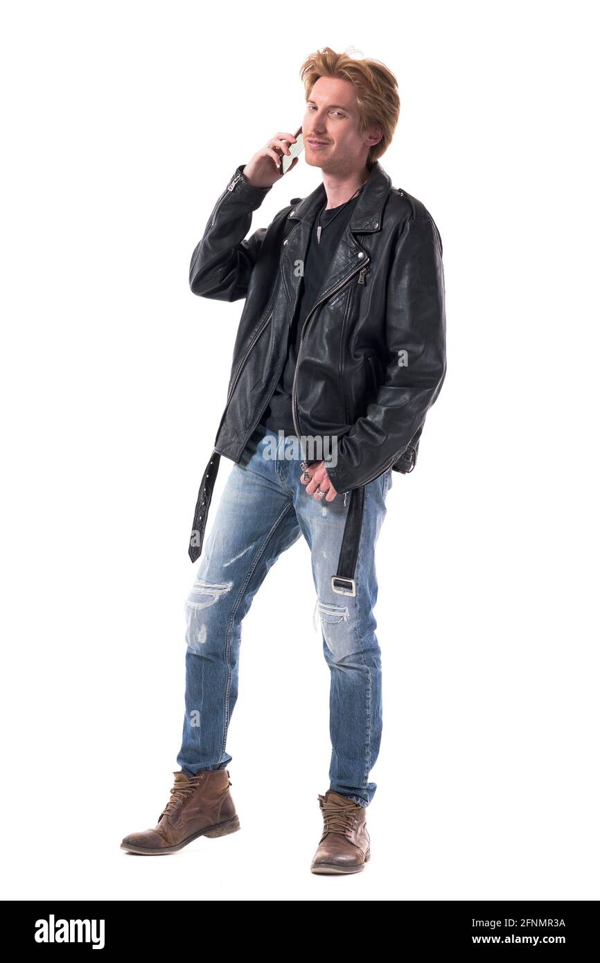 Cool handsome young rocker male talking on the phone smirking and ...