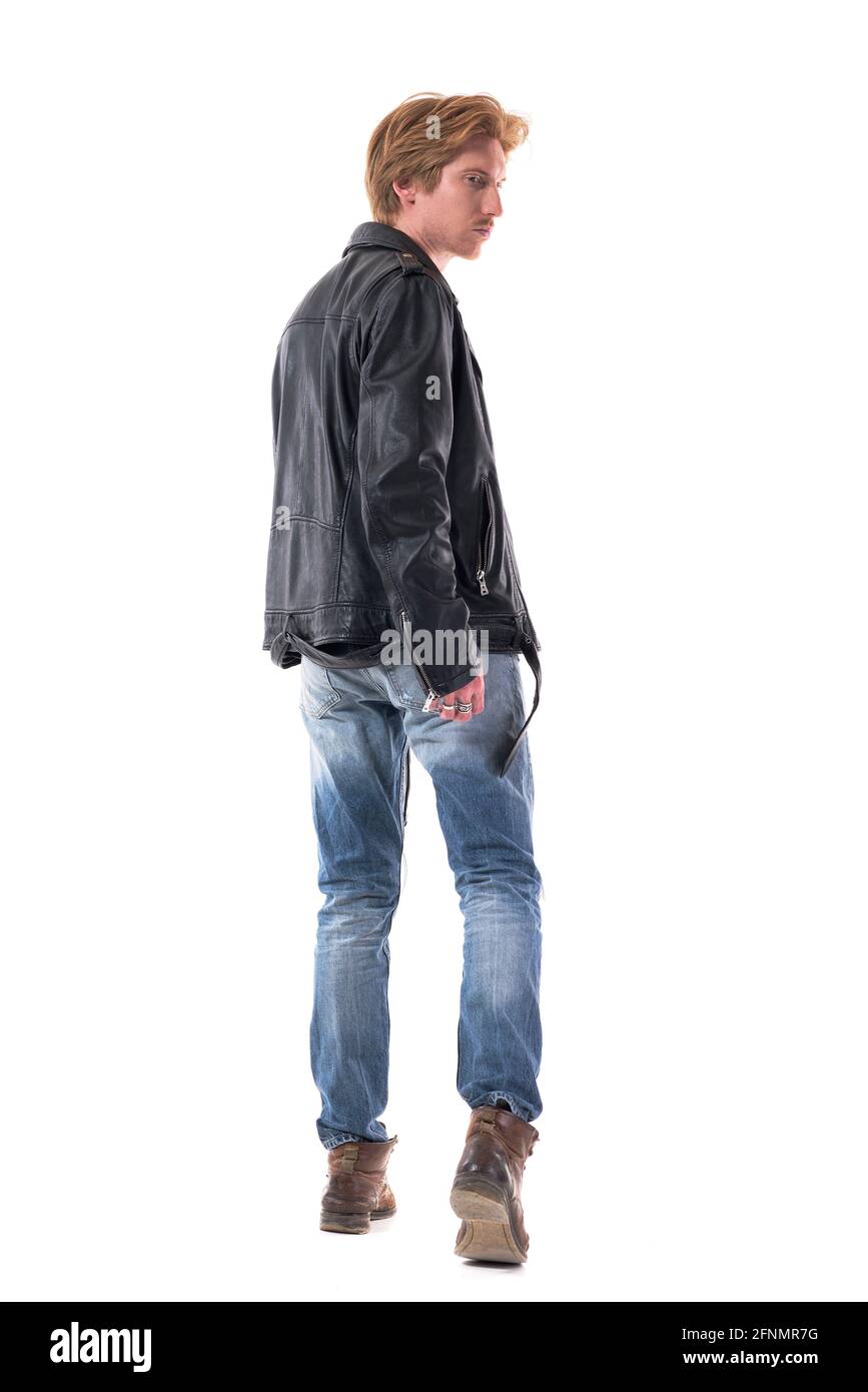 Back view of stylish young rocker man distracted turning behind. Full ...