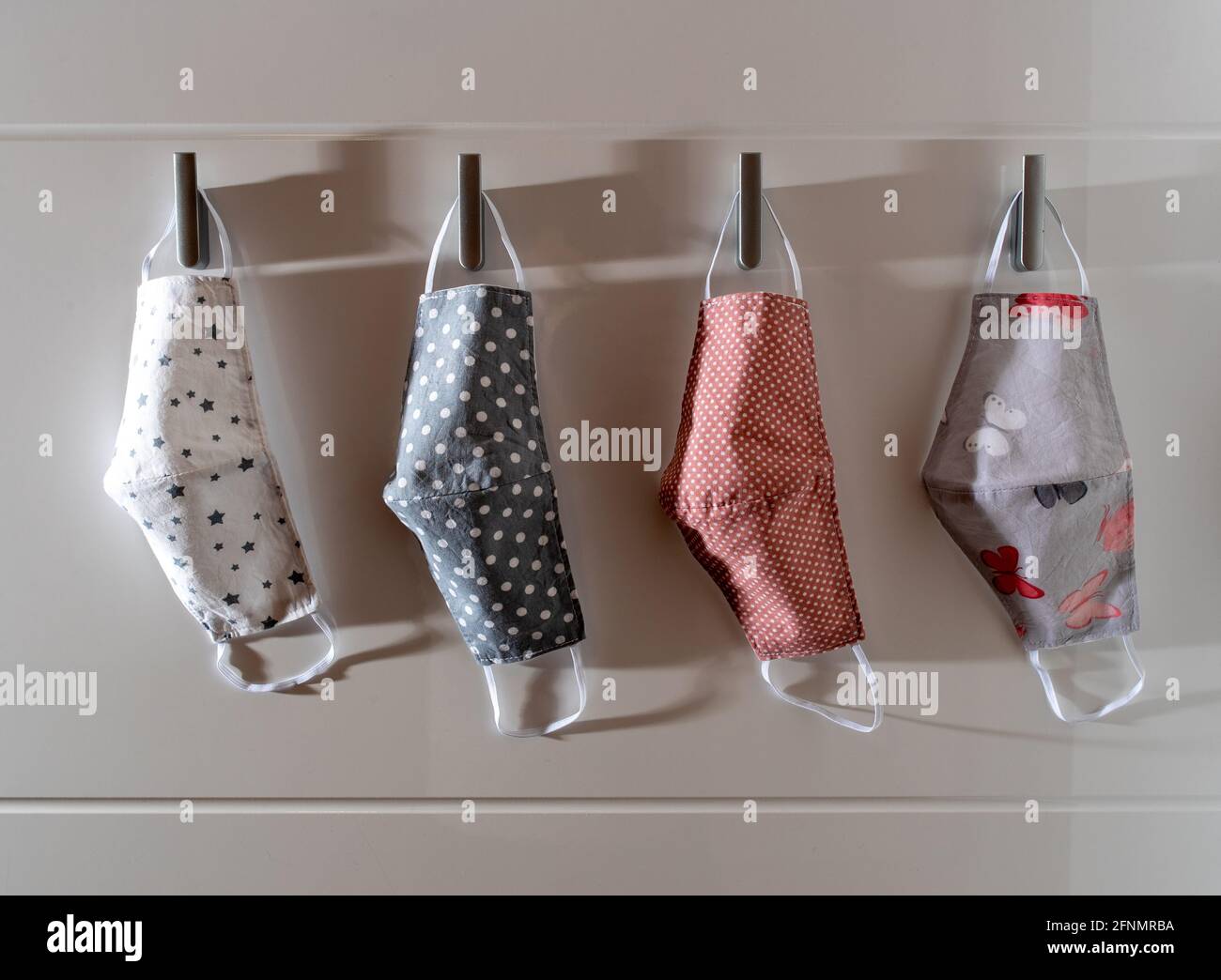 Protective face masks hang hi-res stock photography and images - Alamy